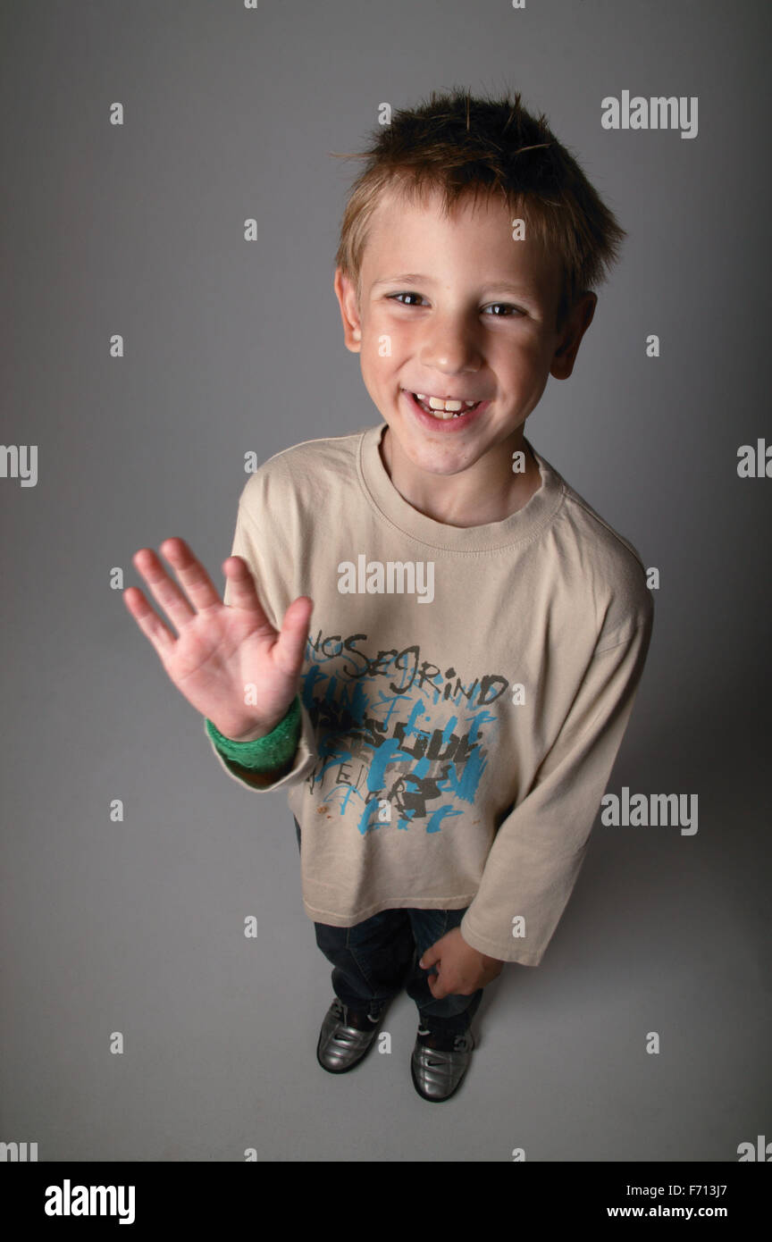 Young boy waving Stock Photo - Alamy