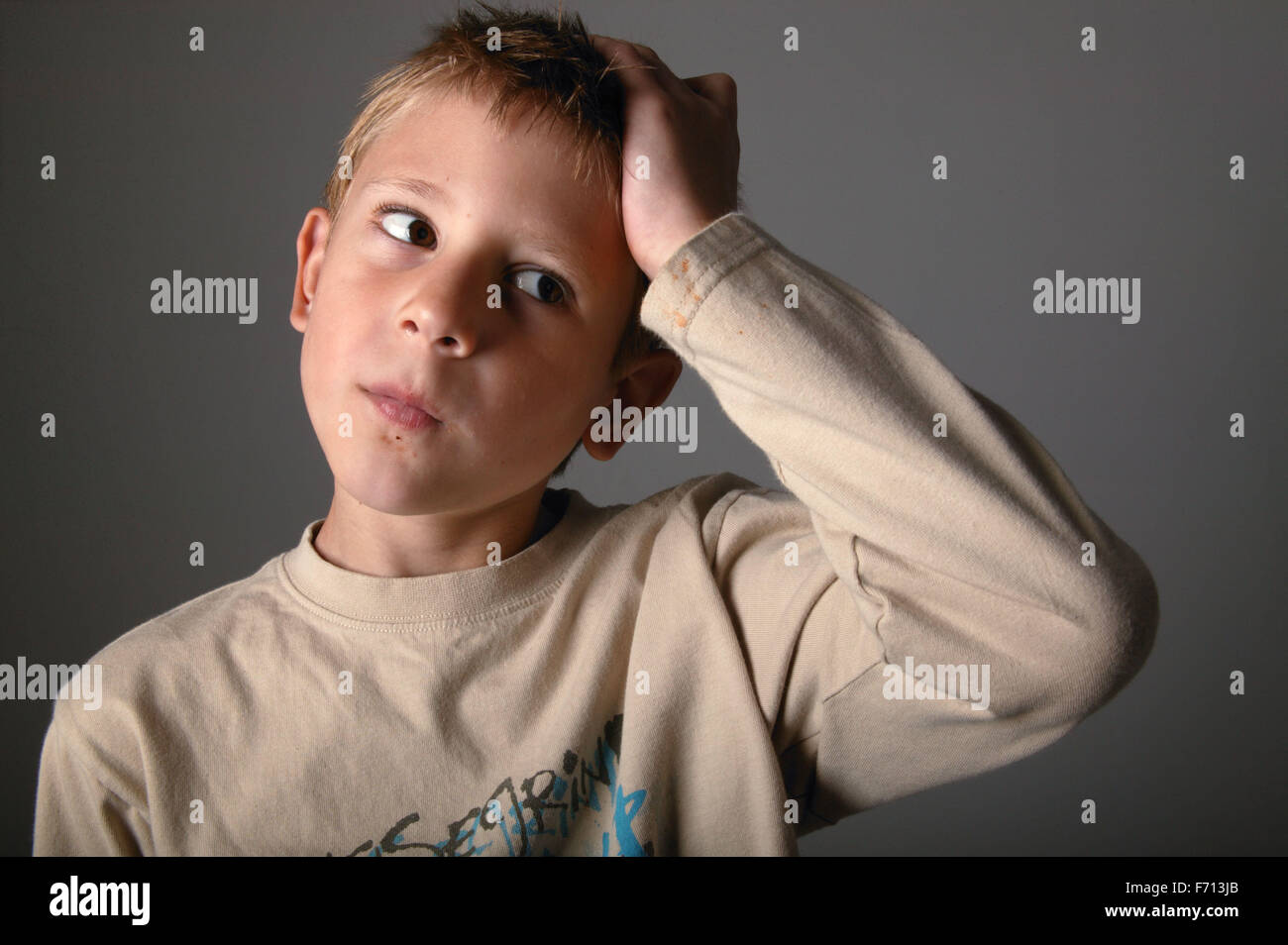 Portrait of a young boy looking puzzled Stock Photo - Alamy