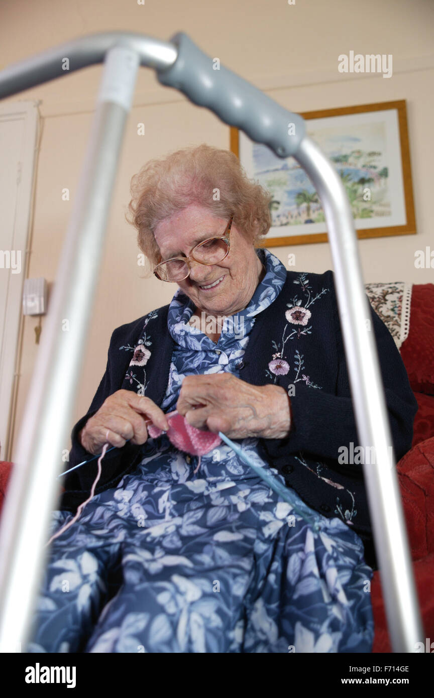 View through a walking frame of an elderly woman knitting at home Stock ...