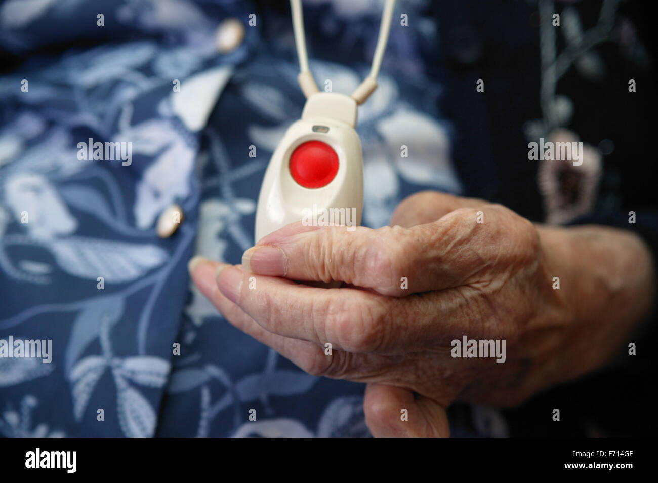 Elderly woman holding a panic buzzer Stock Photo - Alamy