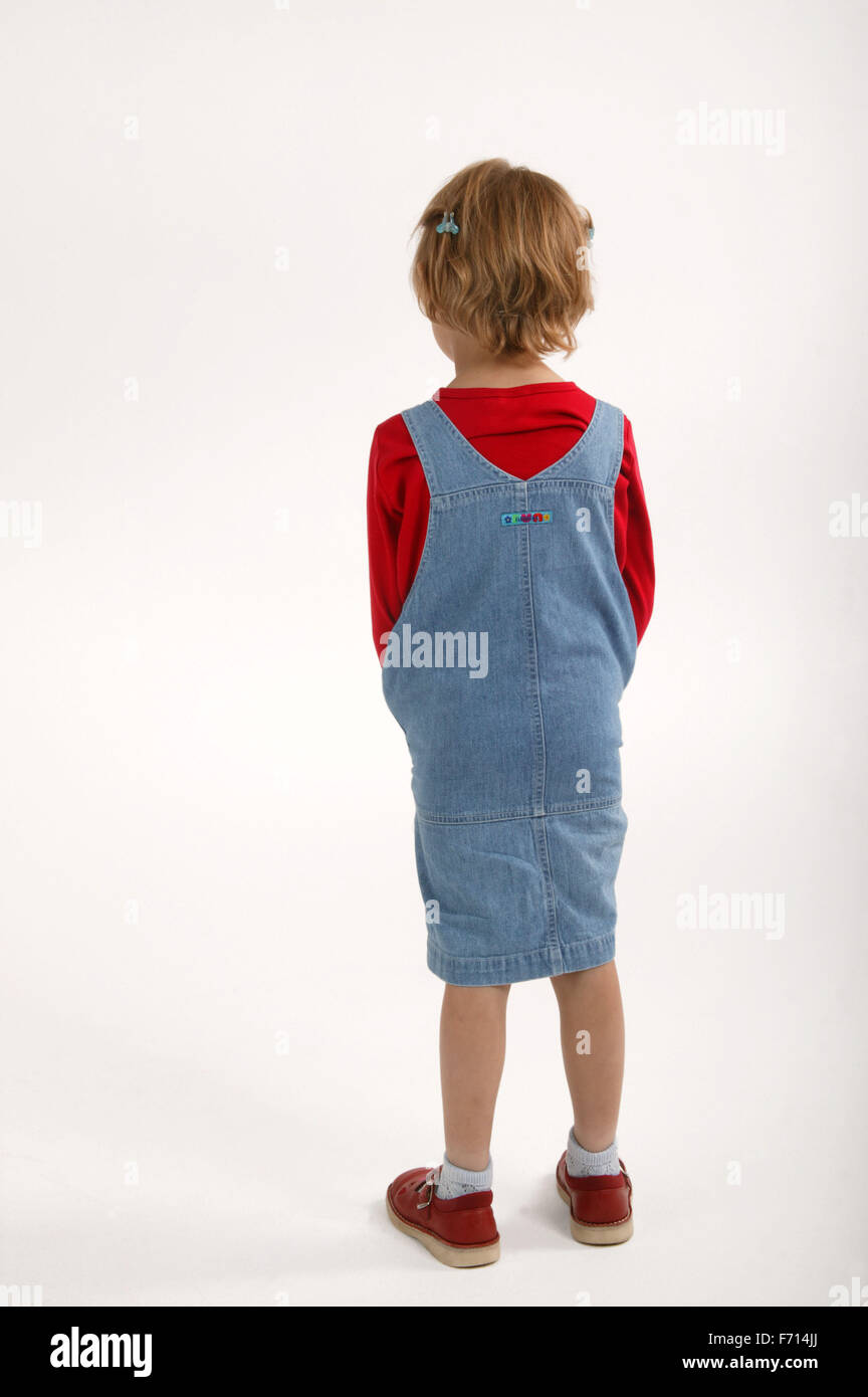 Portrait of young girl standing with her back to the camera Stock Photo ...