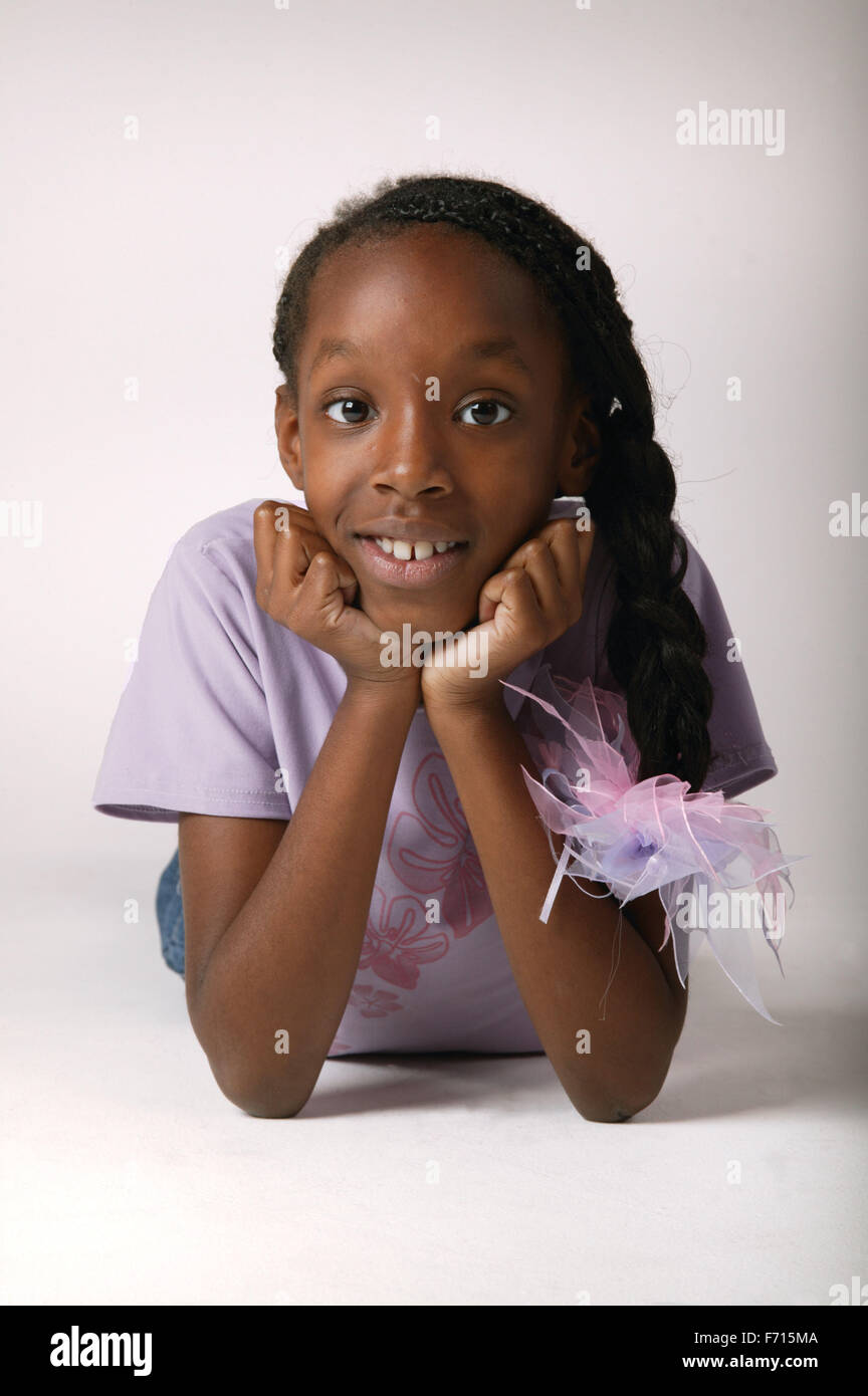 Portrait of girl leaning on elbows Stock Photo - Alamy