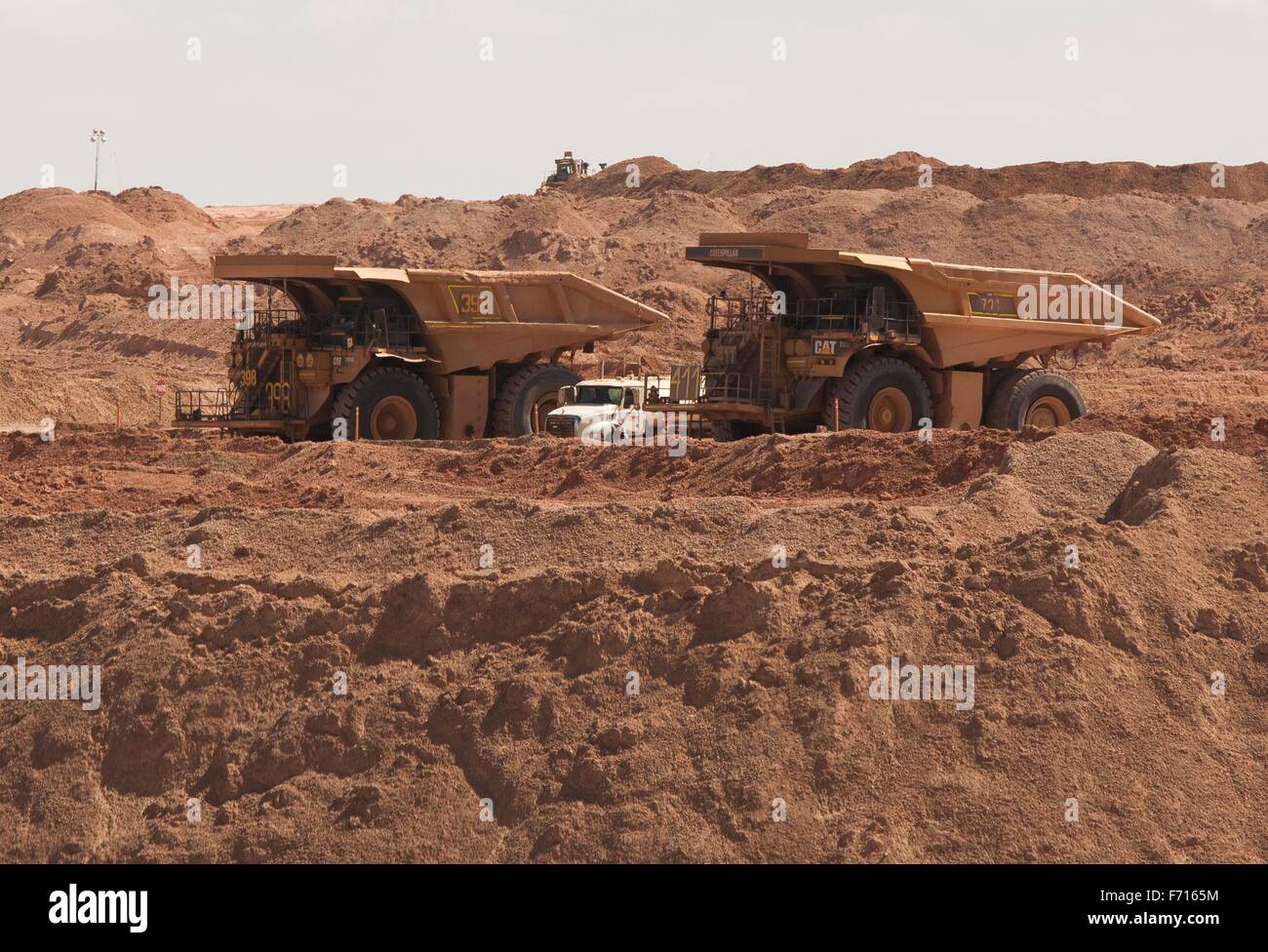 Industrial dumper trucks sit in a quarry in the Atacama desert in ...