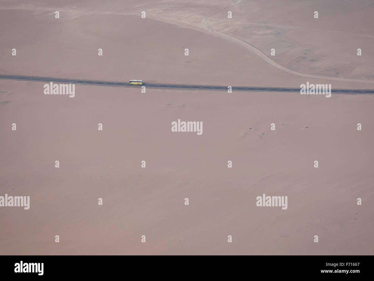 A bus travels through the Atacama desert in northern Chile Stock Photo ...