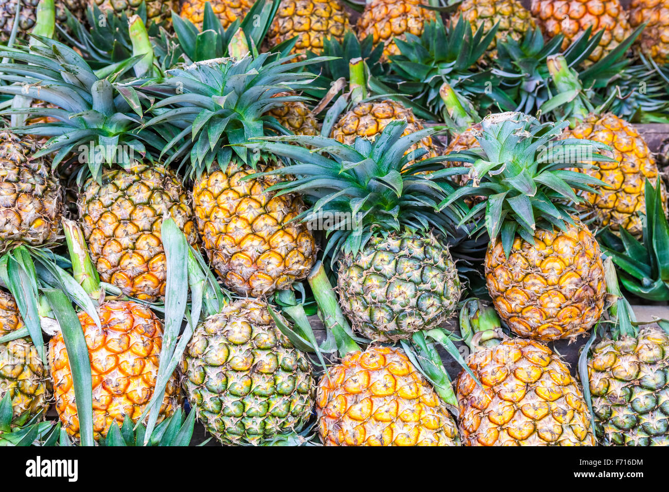 many pineapples together on an table on the market Stock Photo - Alamy
