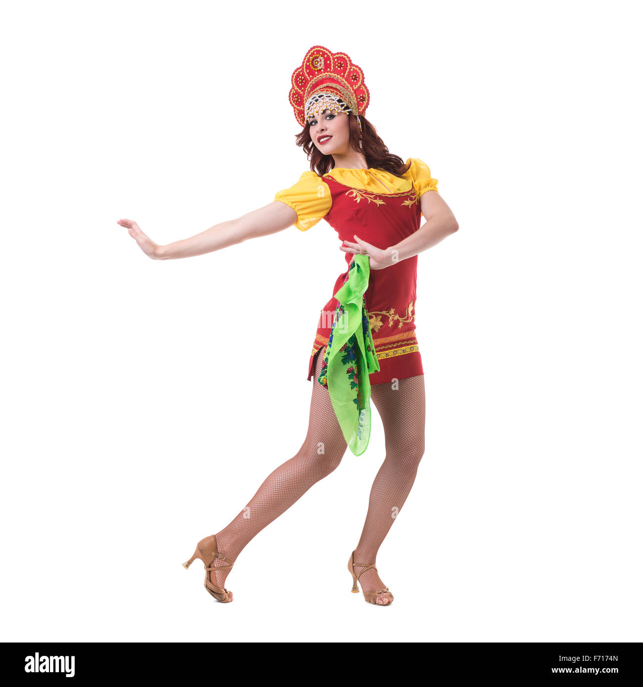 Young woman wearing a folk costumes dancing. Isolated on white in full ...