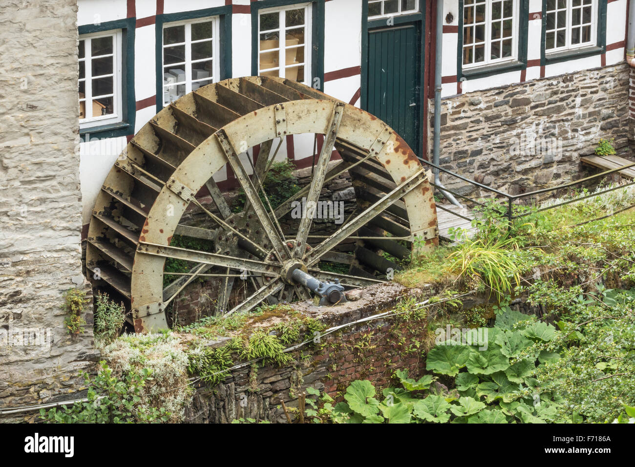 Water mill at the backside of a building Stock Photo - Alamy