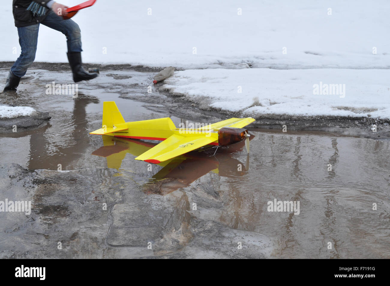 Boy picks up a model plane that fell in a puddle, Kovrov, Russia Stock ...