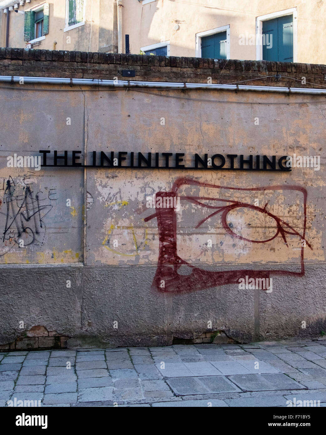 Venice, Italy. 'The Infinite Nothing' sign and graffiti on urban wall ...