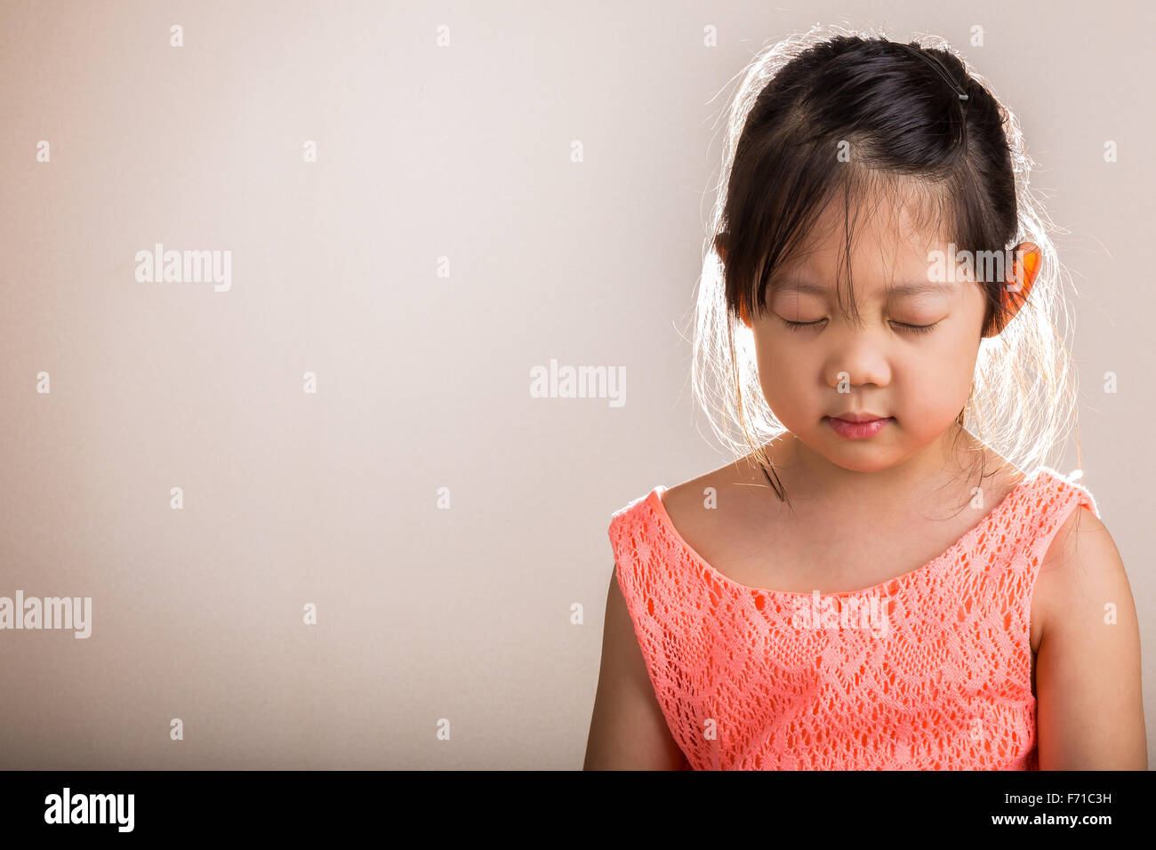 Little girl does mediation alone on with white background Stock Photo ...