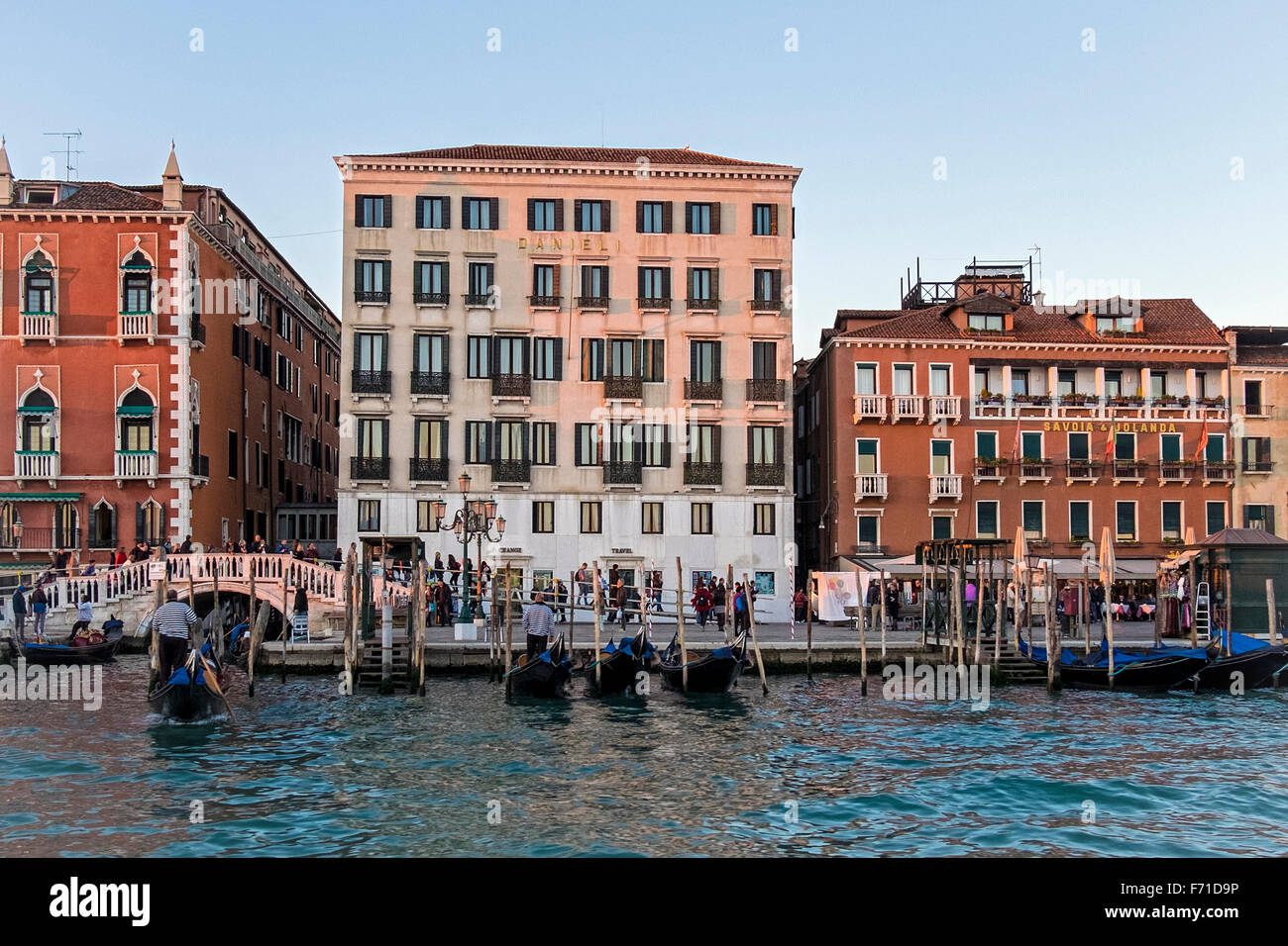Italy, Venice, waterside view of Danieli Hotel bridge, gondolas and ...