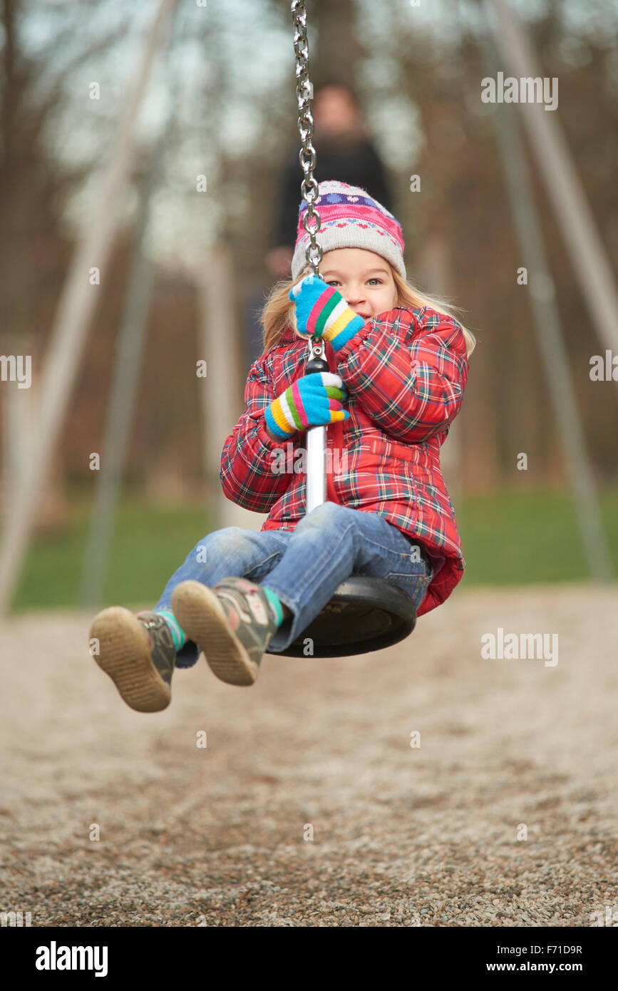 Child girl rids on Flying Fox play equipment in a children's playground ...