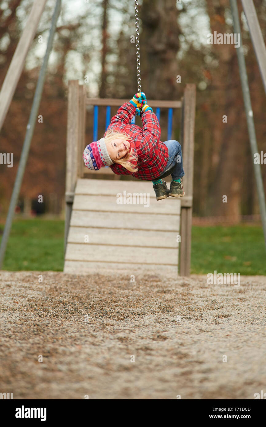 Child girl rids on Flying Fox play equipment in a children's playground ...