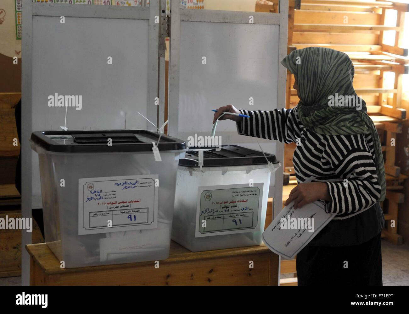 Cairo, Egypt. 23rd Nov, 2015. An Egyptian woman casts her vote at a ...