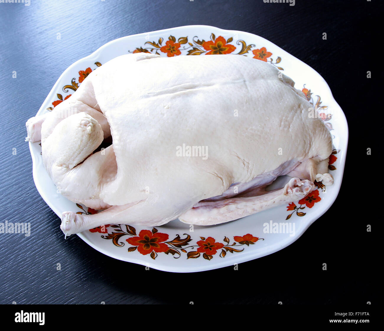 raw duck drake ready to cook on plate black table Stock Photo - Alamy