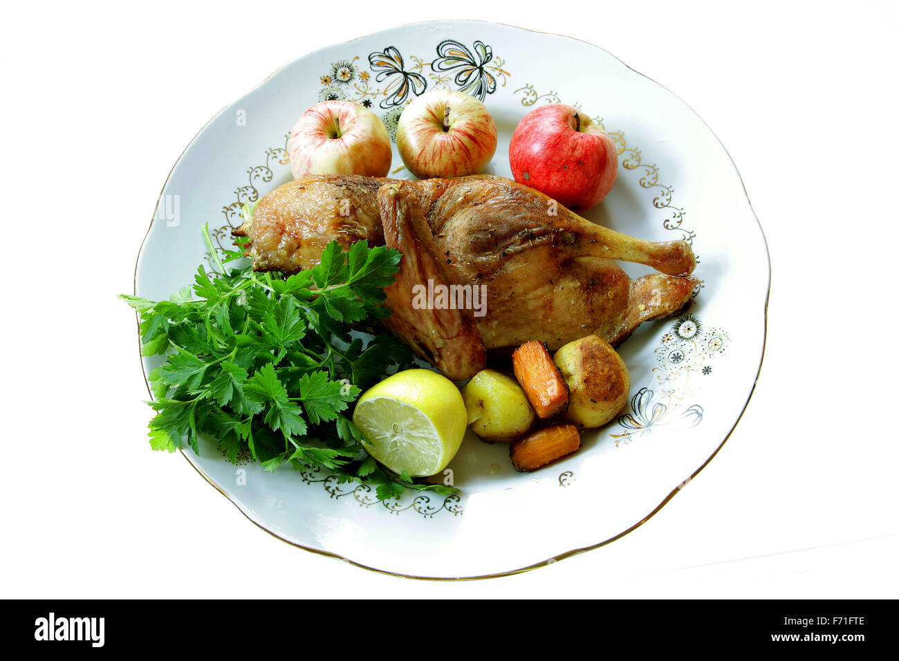 cooked duck drake ready to eat with vegetables and apples isolated on ...