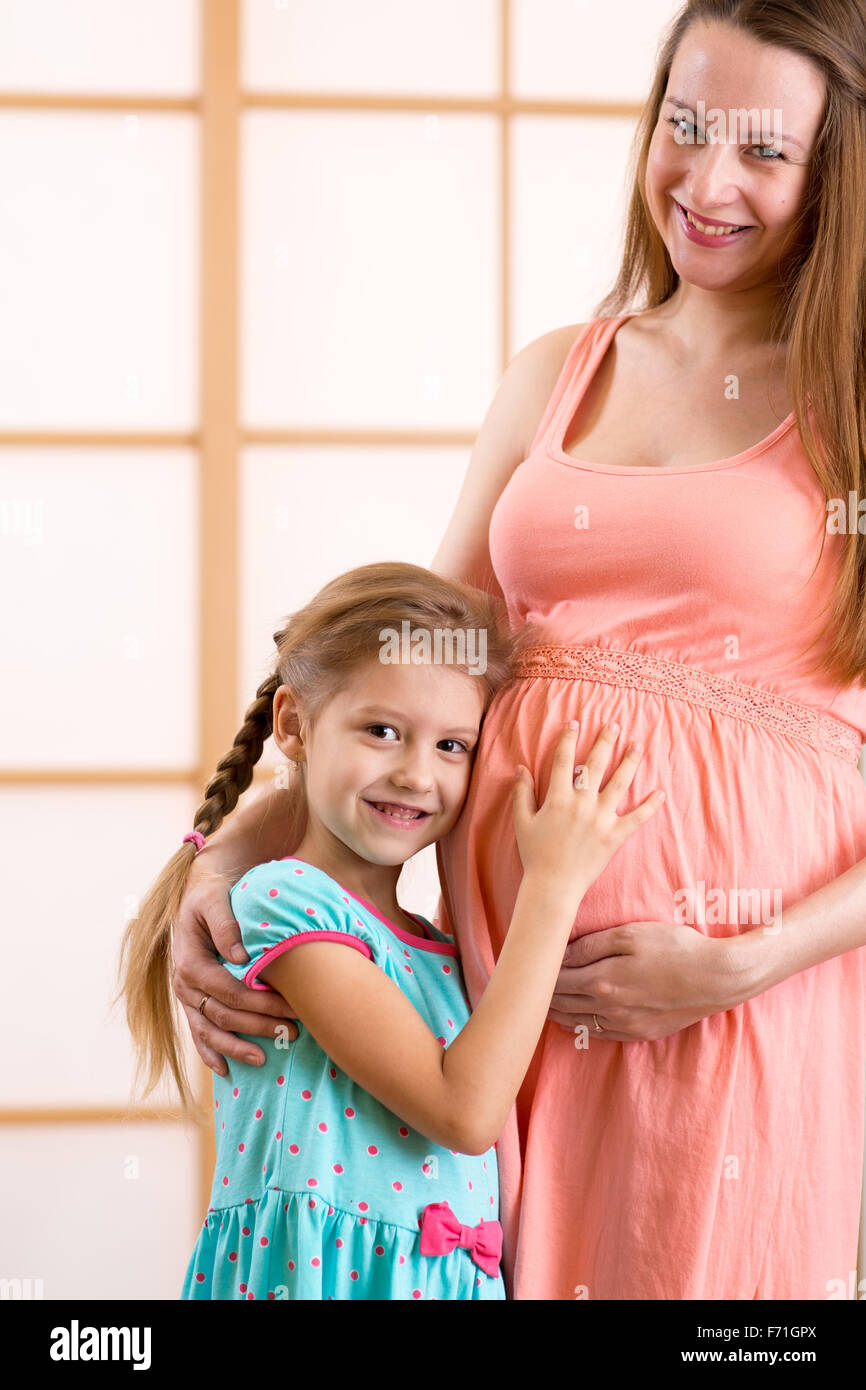 Happy kid girl hugging pregnant mother hi-res stock photography and ...