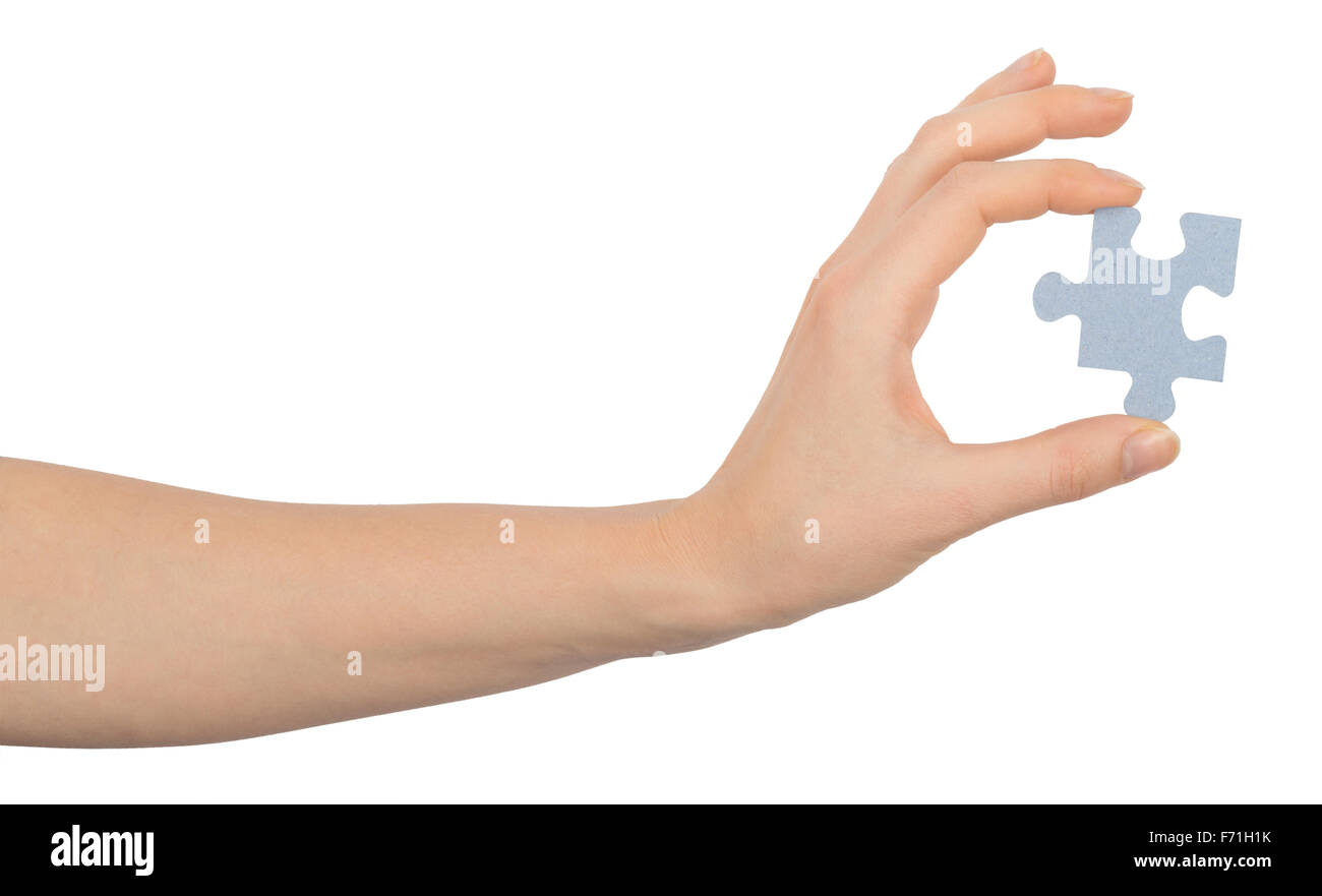 Womans hand holding puzzle piece Stock Photo - Alamy