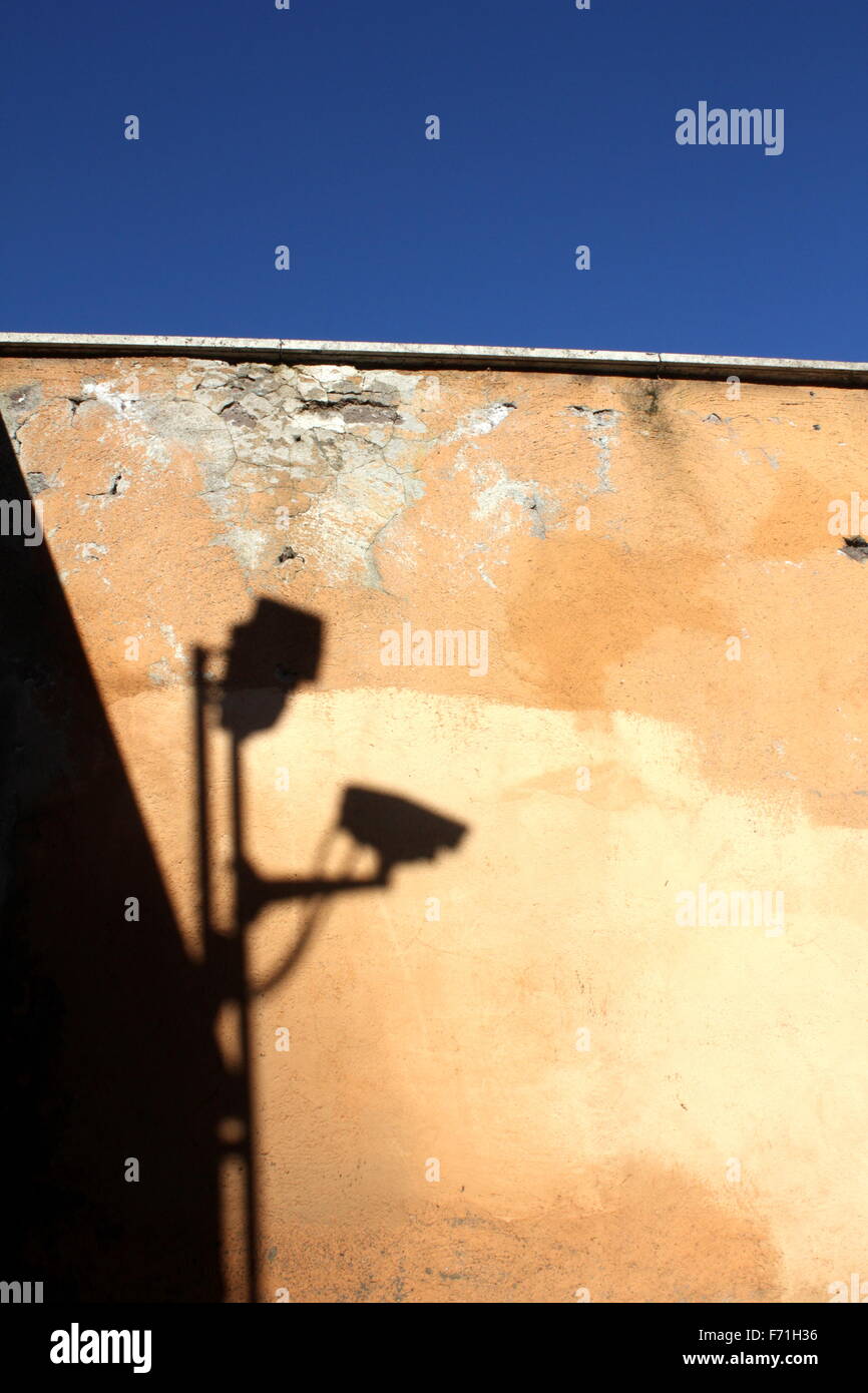 cctv camera and security light pole shadow on wall in rome italy Stock ...