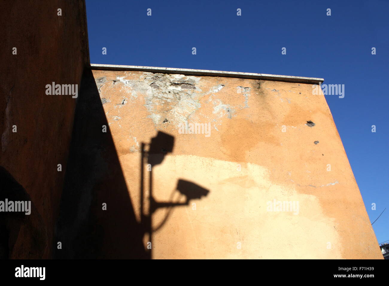 cctv camera and security light pole shadow on wall in rome italy Stock ...