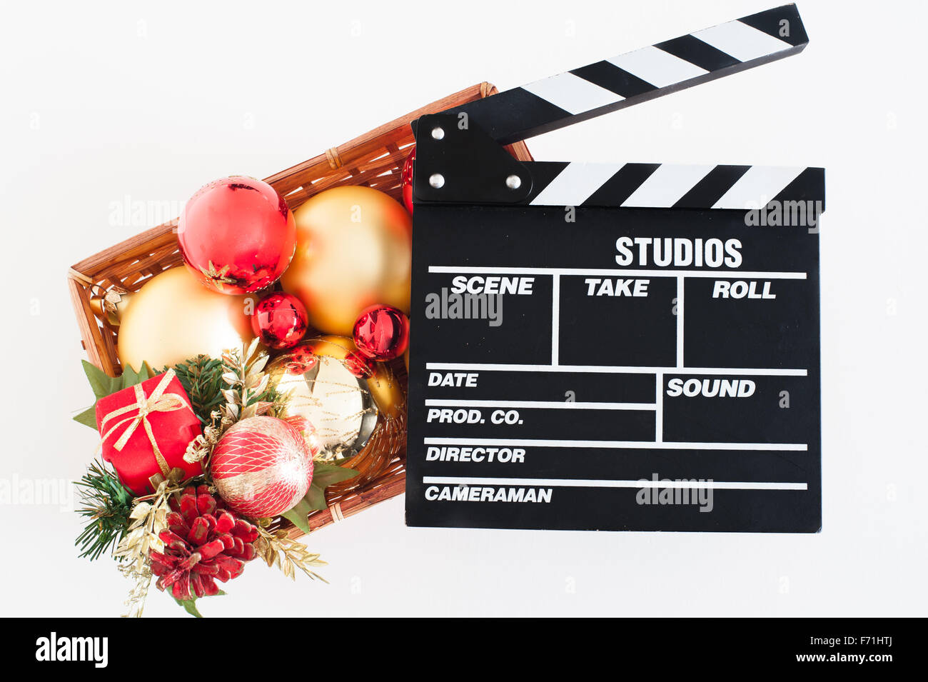 Movie clapper board and christmas decoration red and golden on white ...