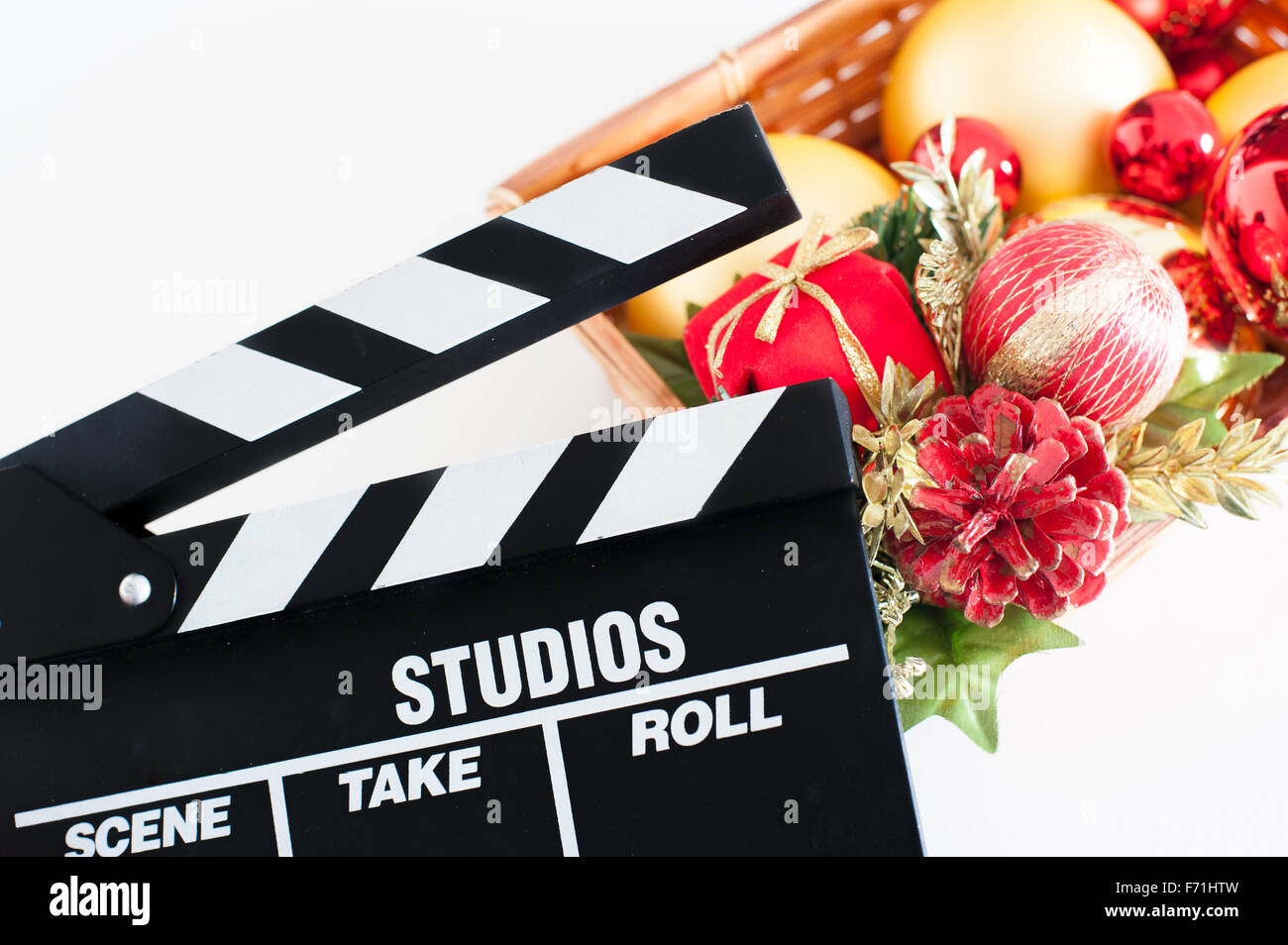 Movie clapper board and christmas decoration red and golden on white ...