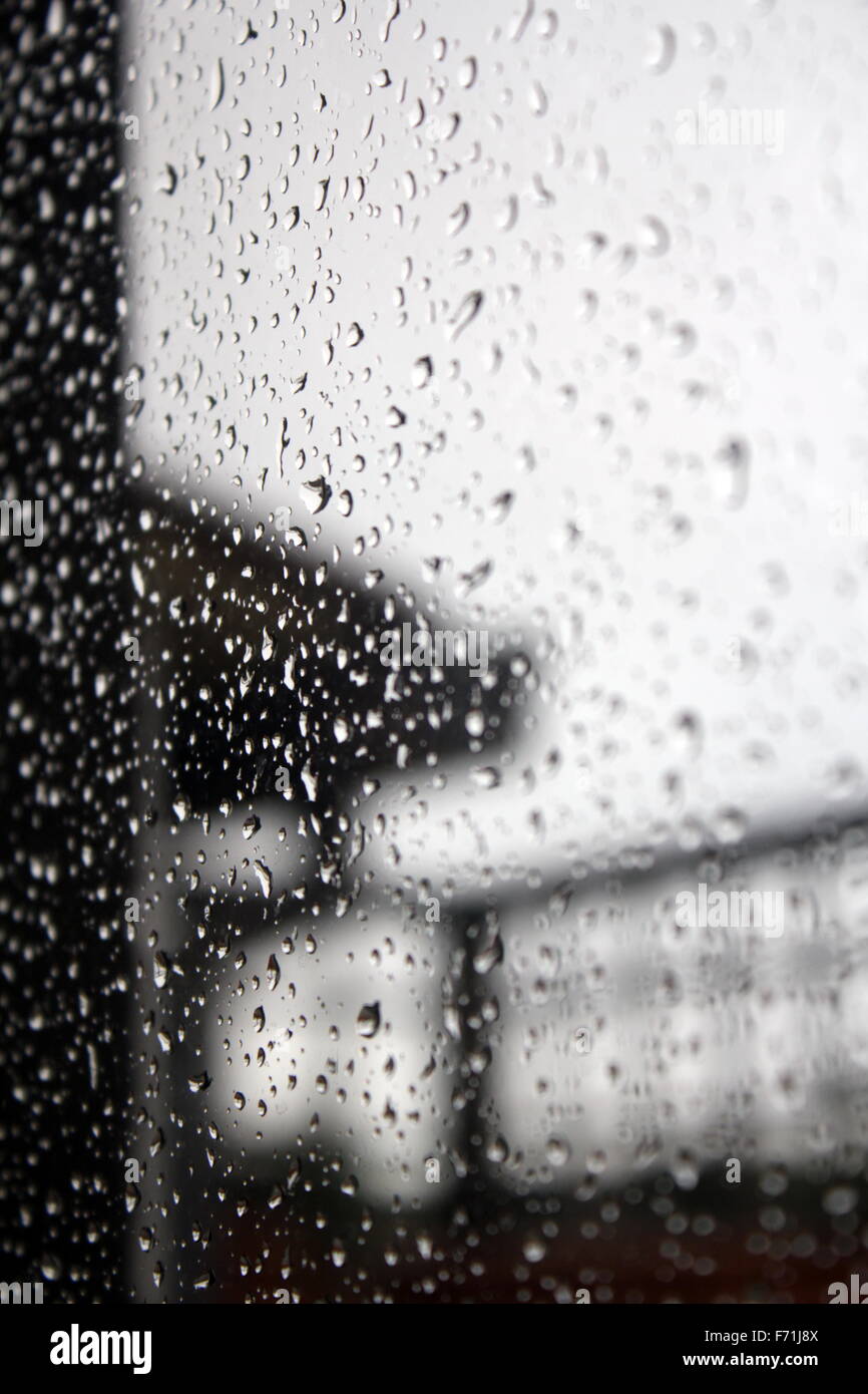rain drops on window with view of garden fence Stock Photo - Alamy