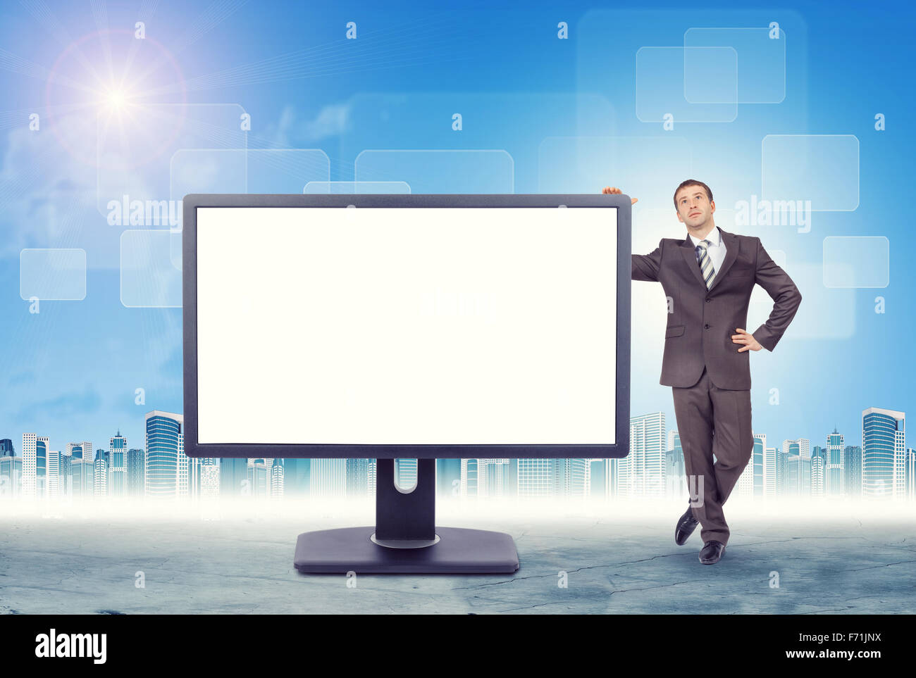 Businessman leaning on monitor Stock Photo - Alamy