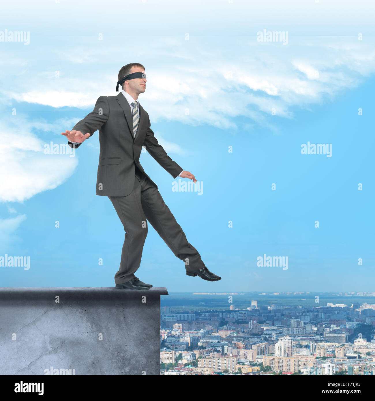 Businessman walking from edge of building roof Stock Photo - Alamy