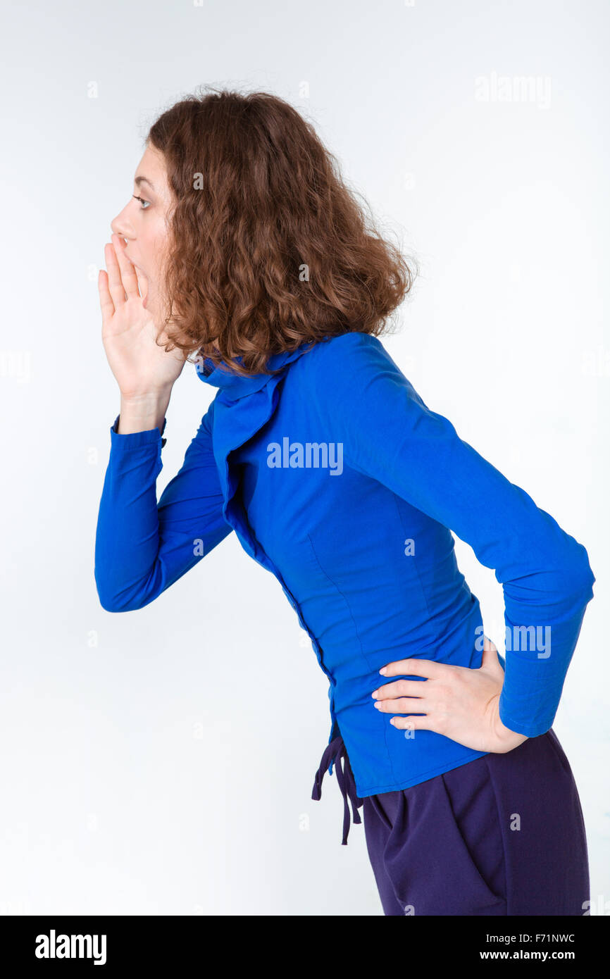 Side view portrait of a young woman shouting isolated on a white ...