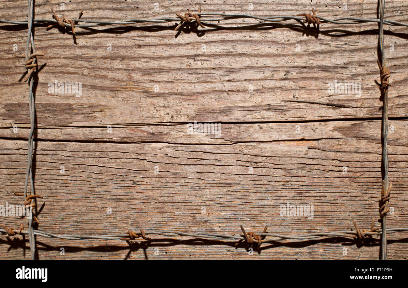 frame made of barbed wire on wooden desk Stock Photo - Alamy