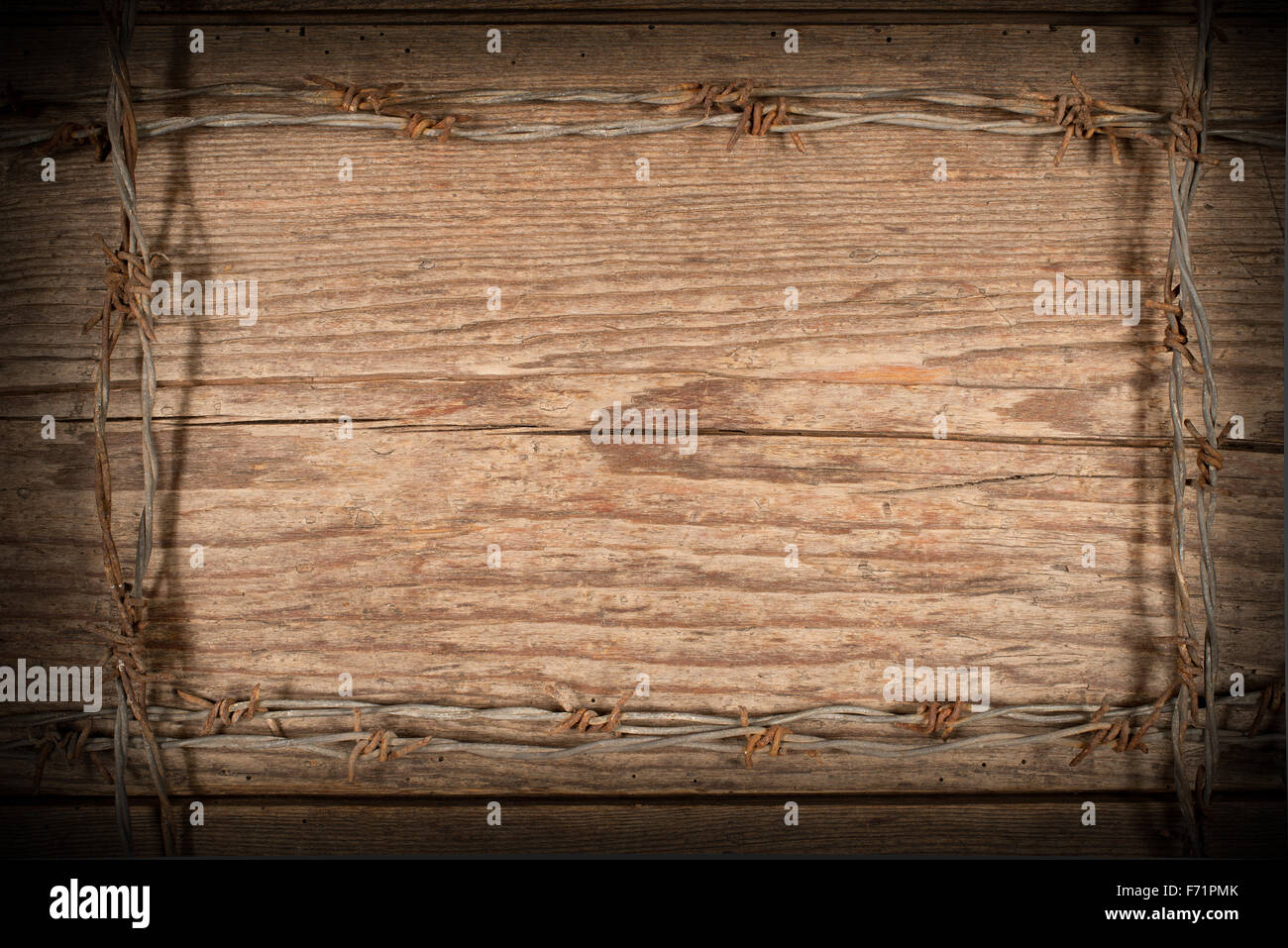 frame made of barbed wire on wooden desk Stock Photo - Alamy
