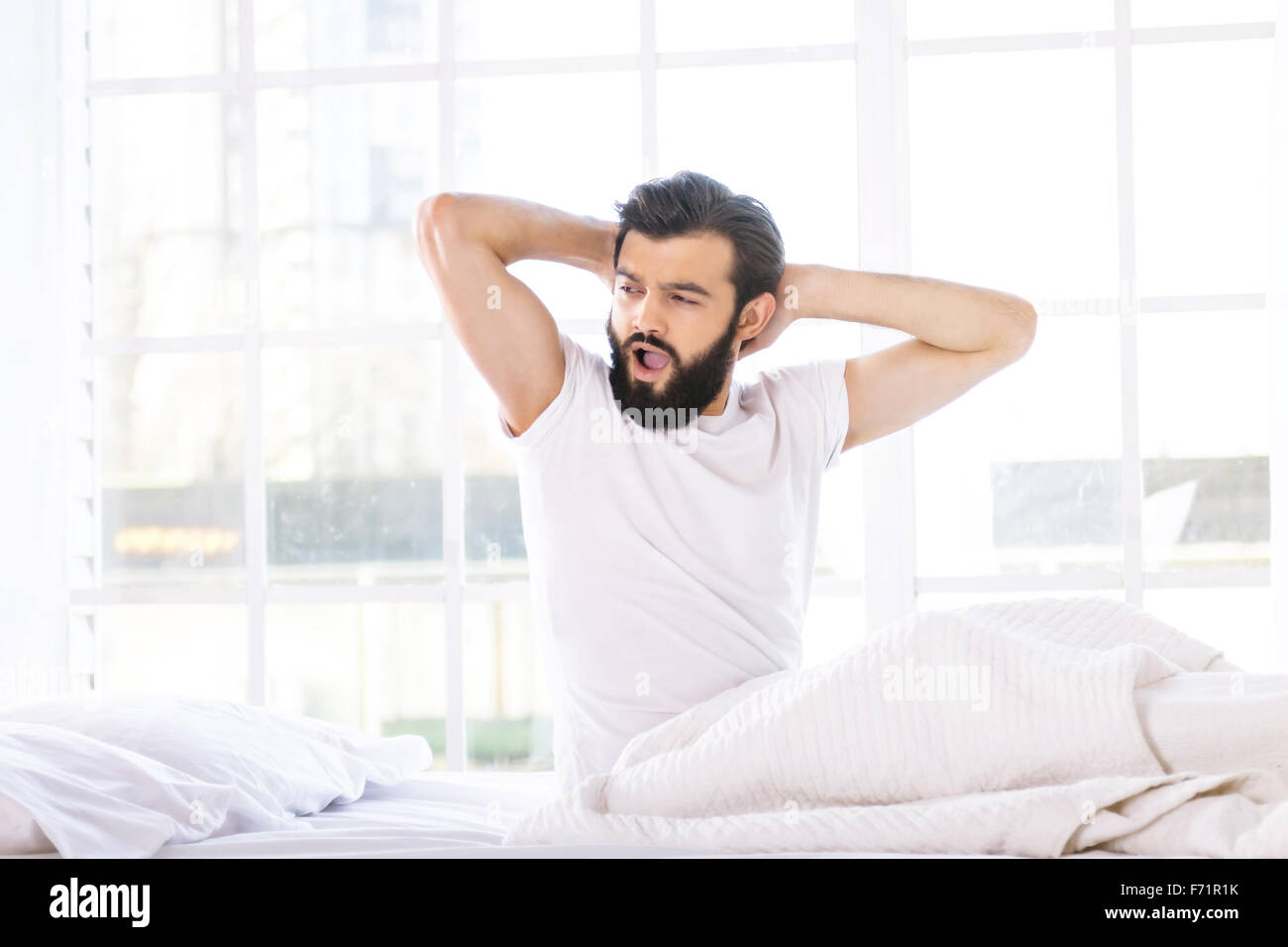 Sleepy young man in the morning Stock Photo - Alamy
