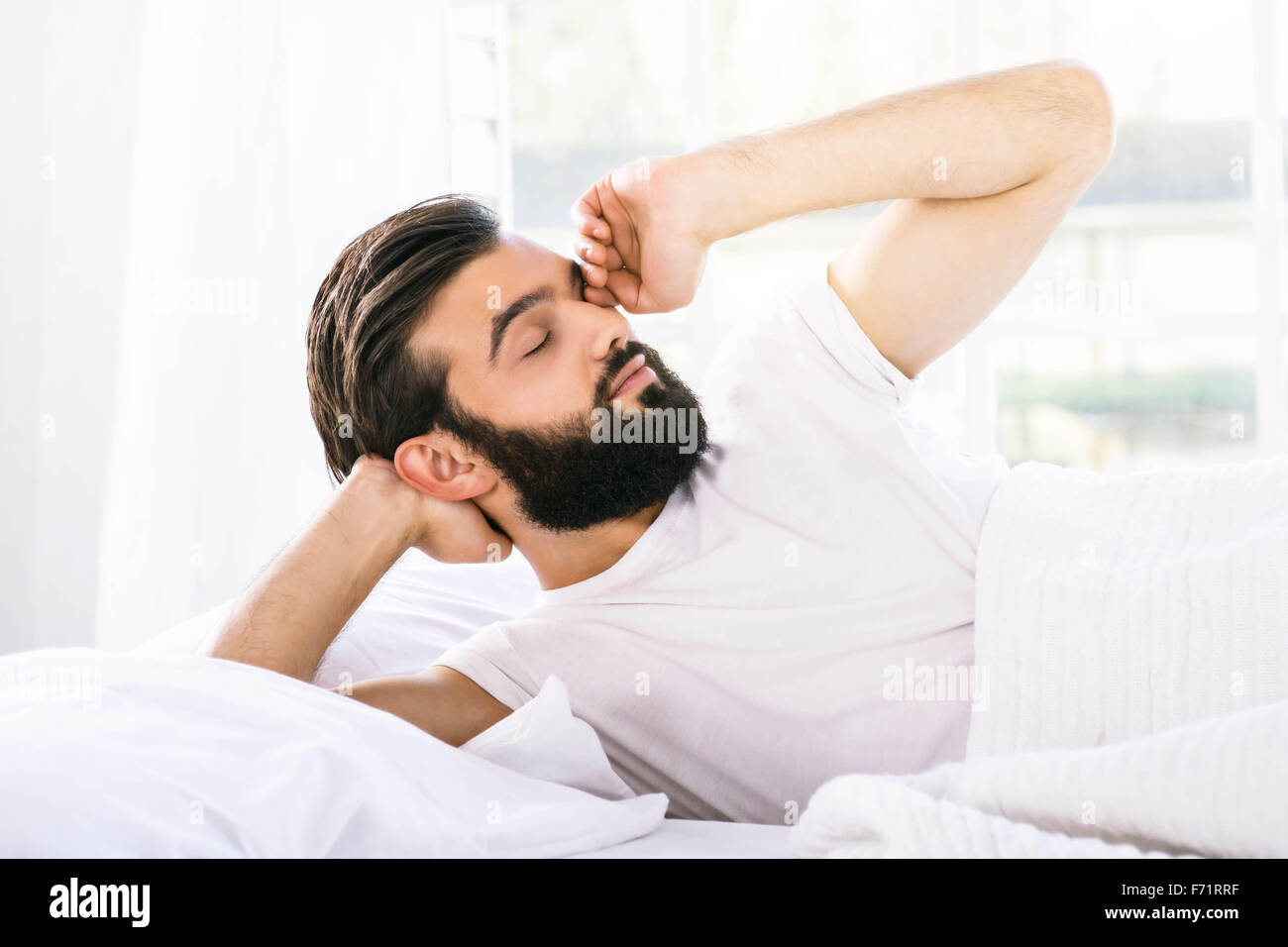Sleepy young man in the morning Stock Photo - Alamy