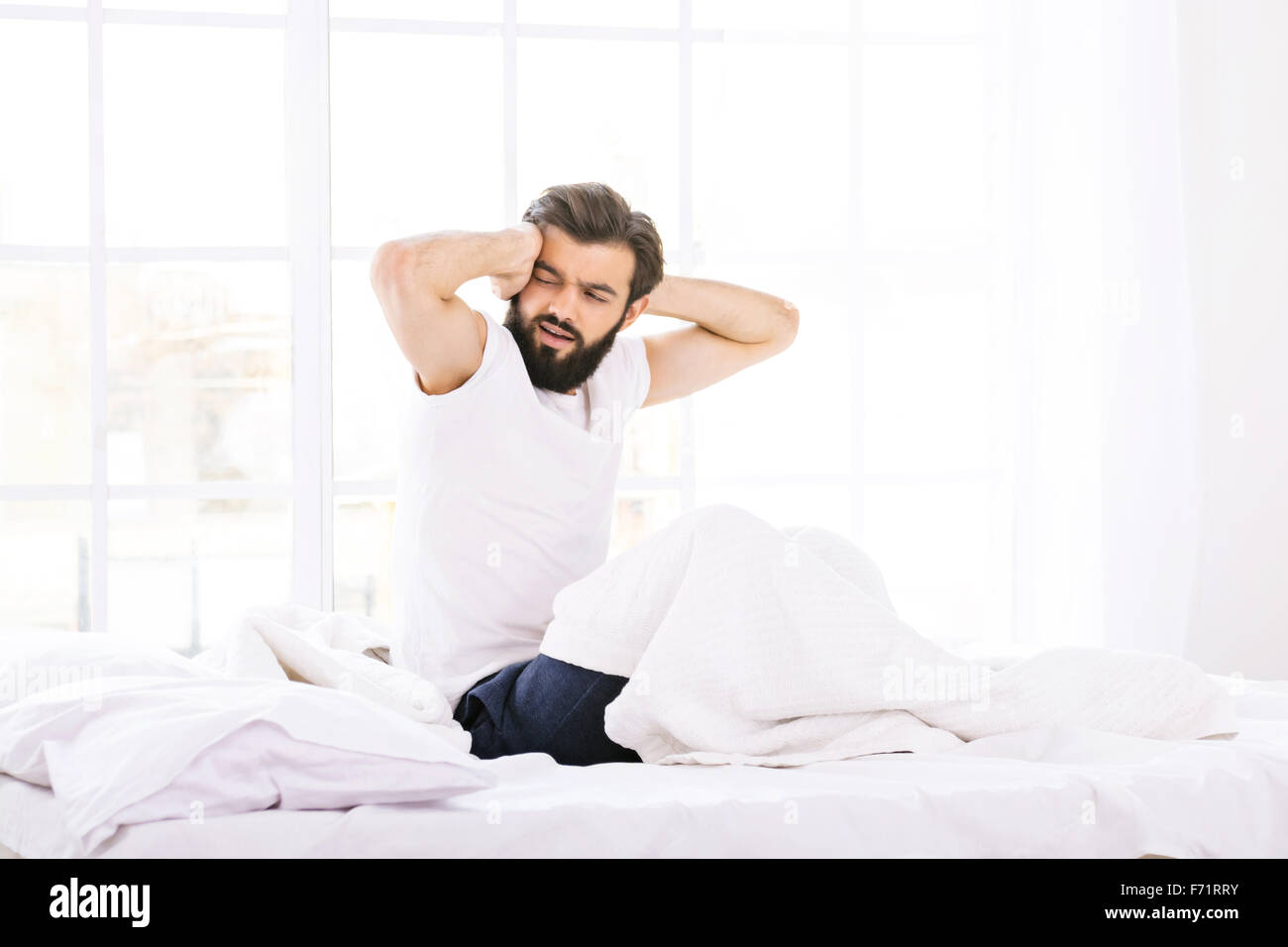 Sleepy young man in the morning Stock Photo - Alamy