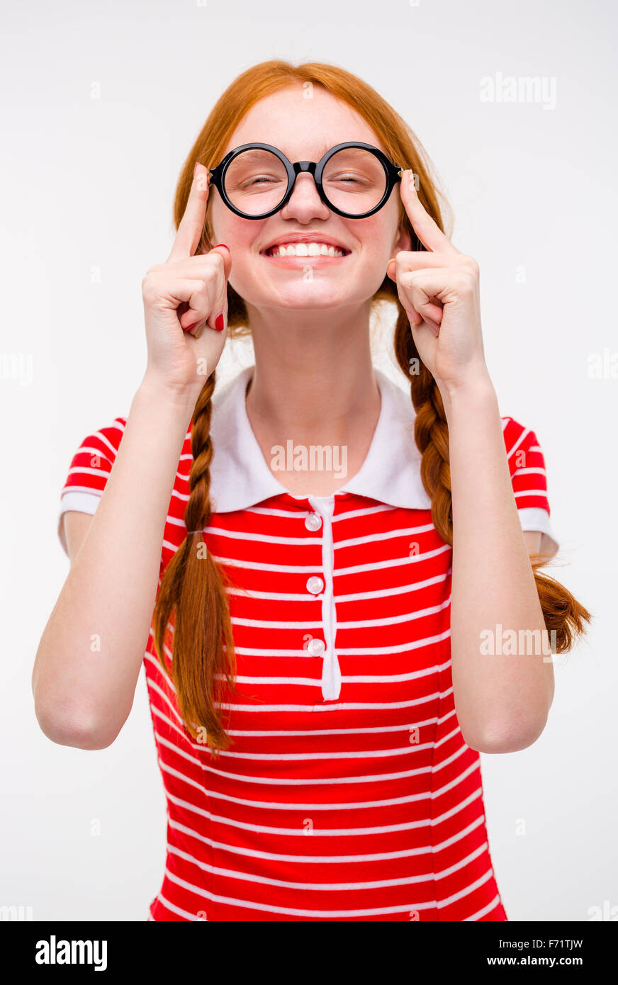 Cheerful pleased funny young female with two braids fixing round ...