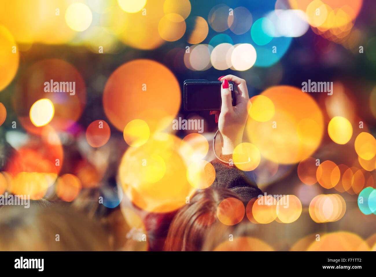 Fans taking pictures of music band performing live on festival stage ...