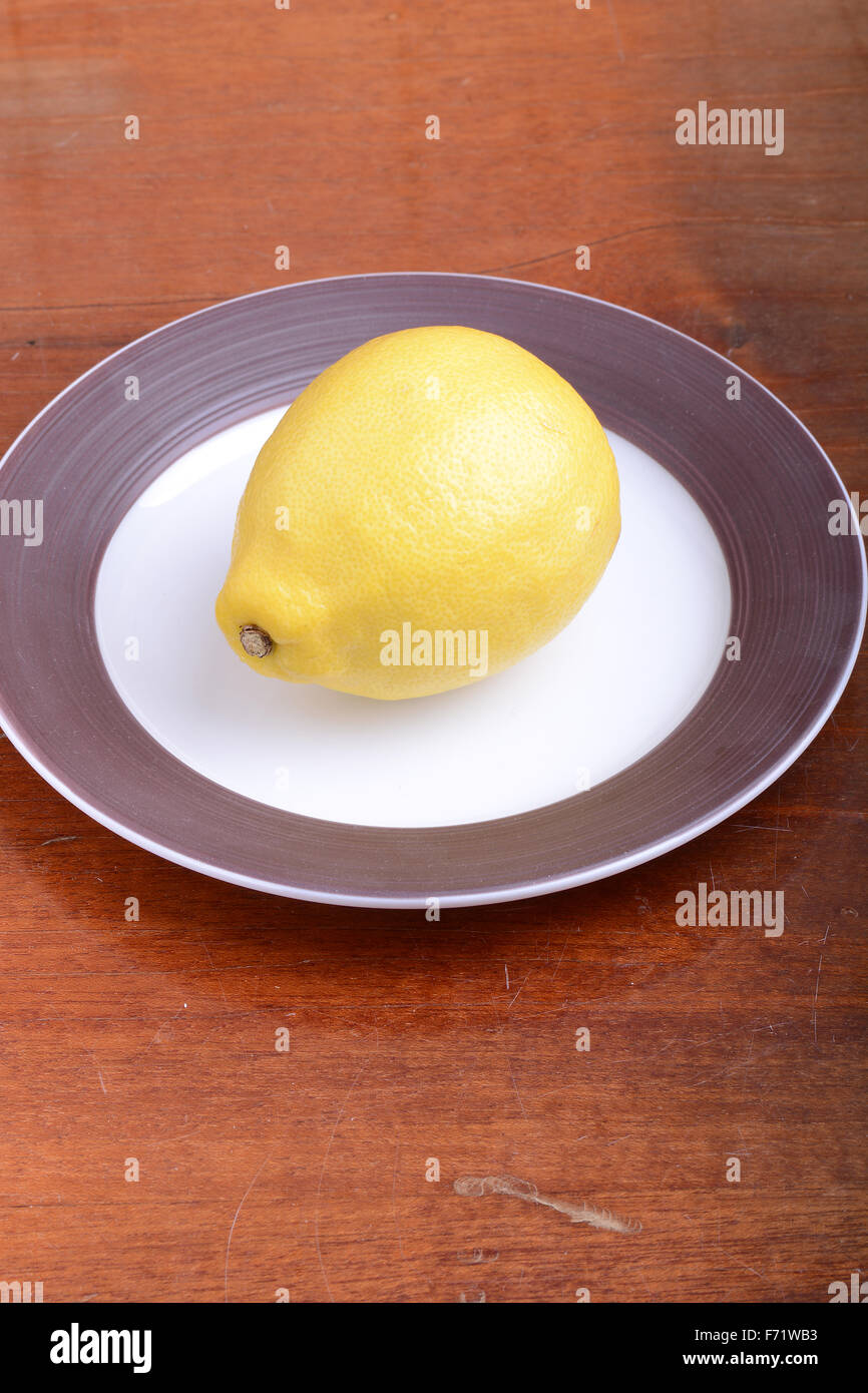 fresh lemon on grey plate Stock Photo - Alamy