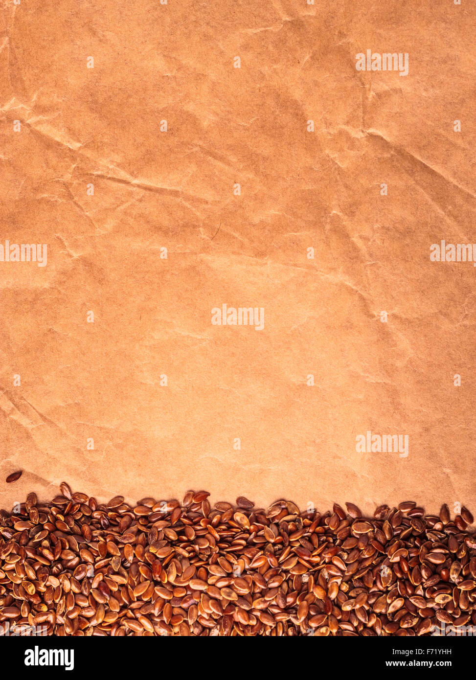 Healthy diet organic nutrition. Brown raw flax seeds linseed border frame on paper background ...