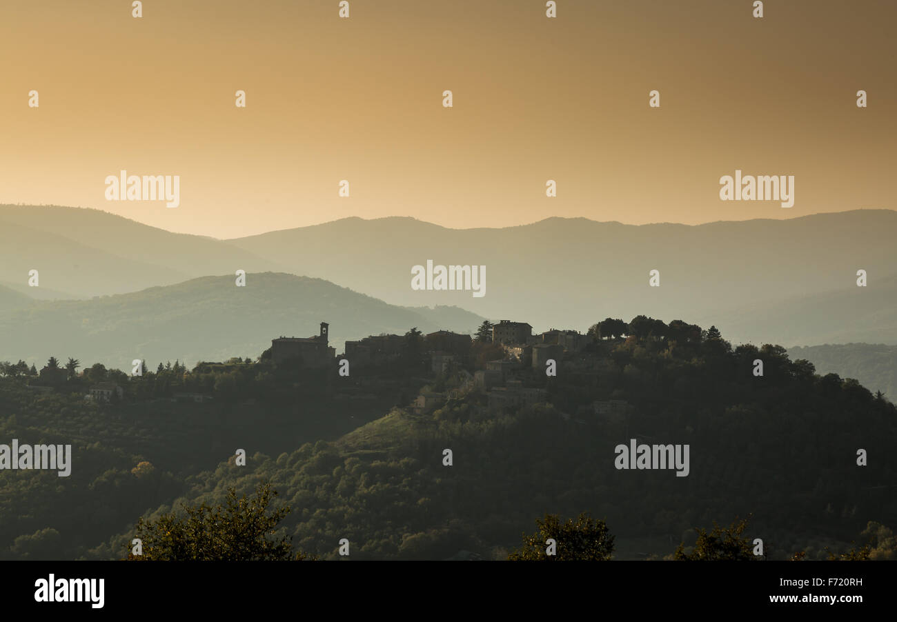 Houses and church of Hilltop village of Preggio silhouetted against the ...