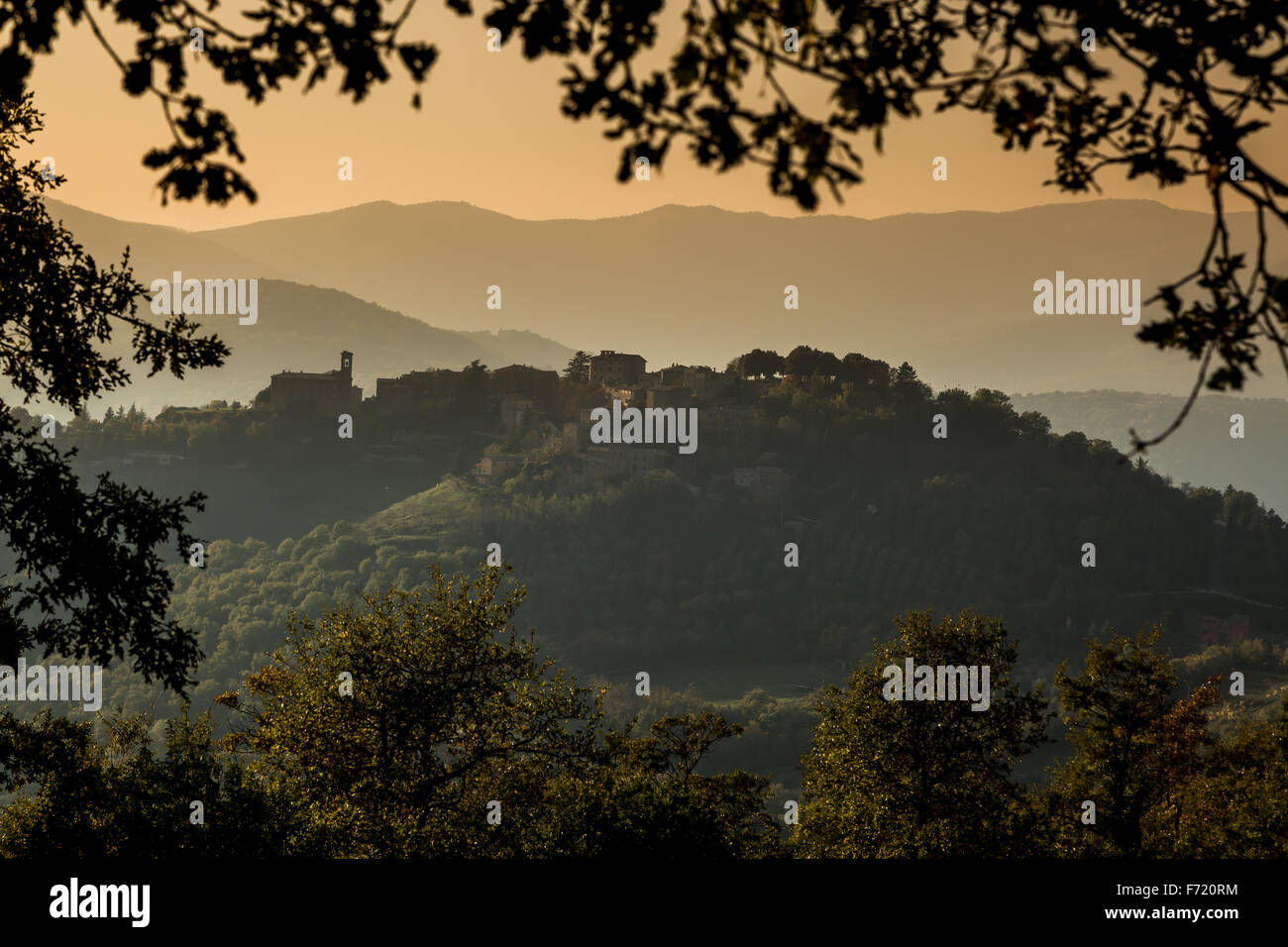 Houses and church of Hilltop village of Preggio silhouetted against the ...