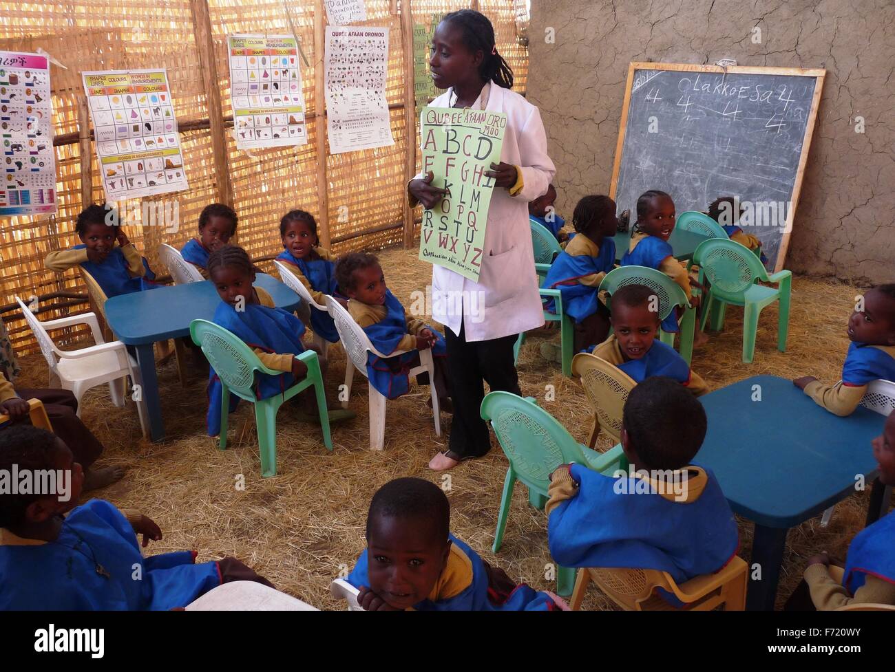 A early childhood development teacher reviews the alphabet with young ...
