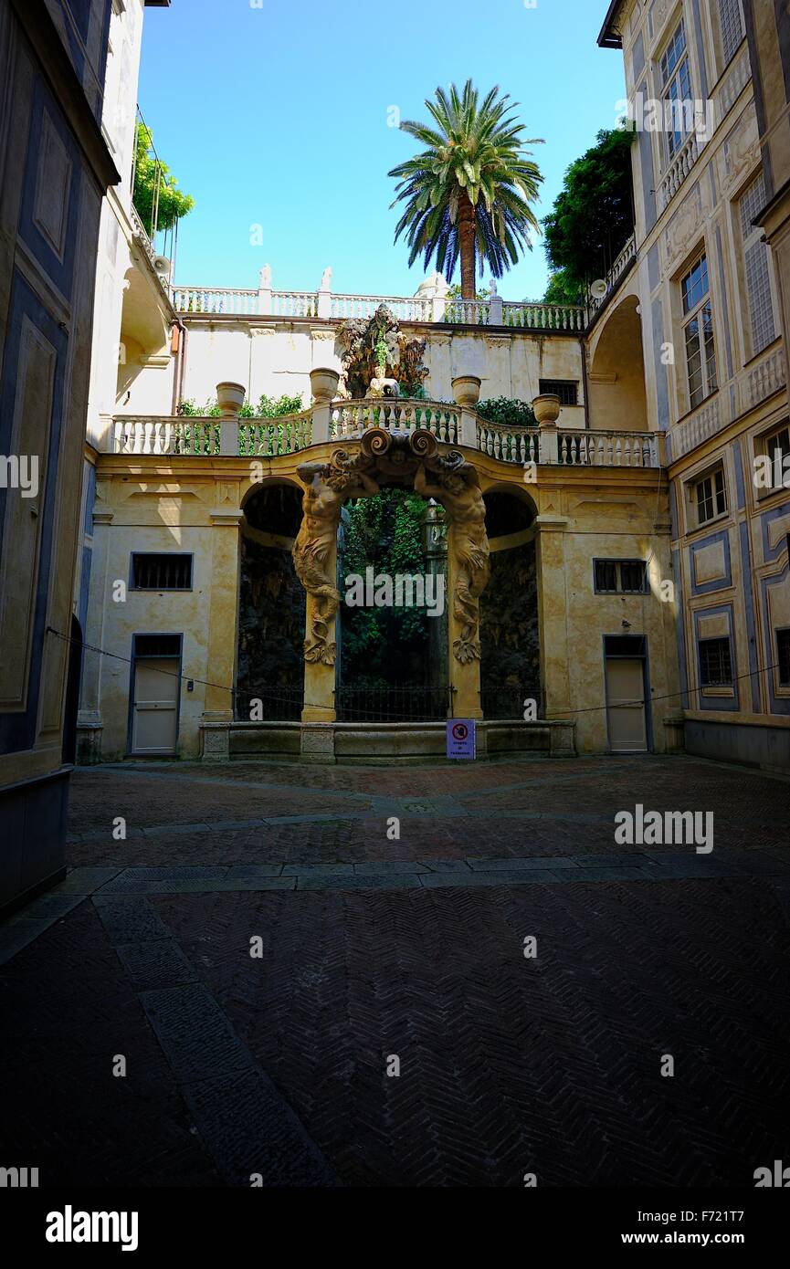 Two Statues forming an arch in the courtyard Stock Photo - Alamy