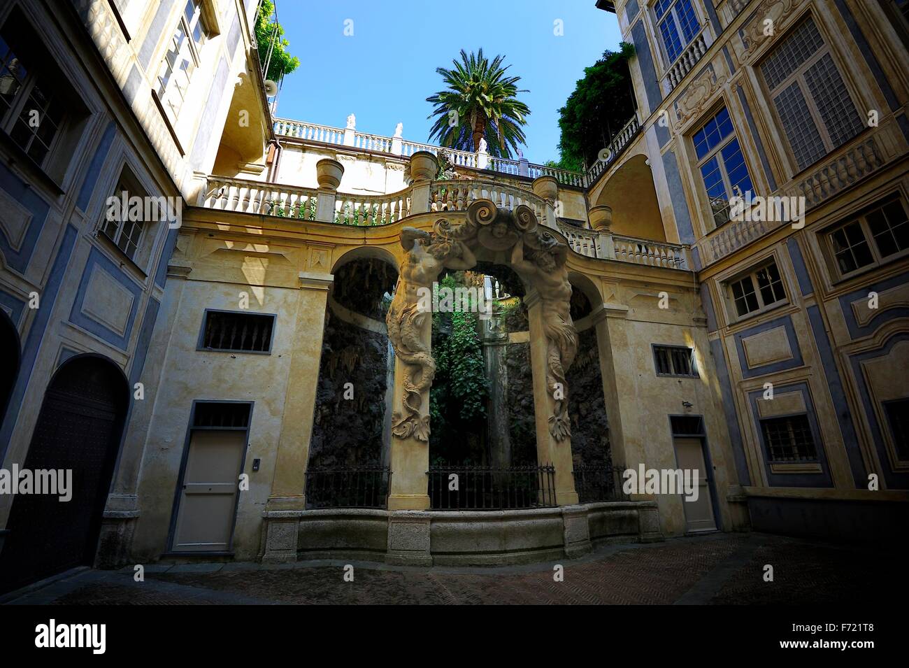 Two Statues forming an arch in the courtyard Stock Photo - Alamy
