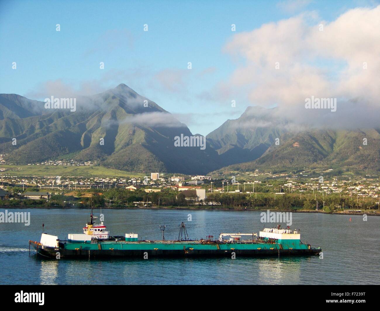 Hawaiian barge in calm water with mountains in the background Stock ...