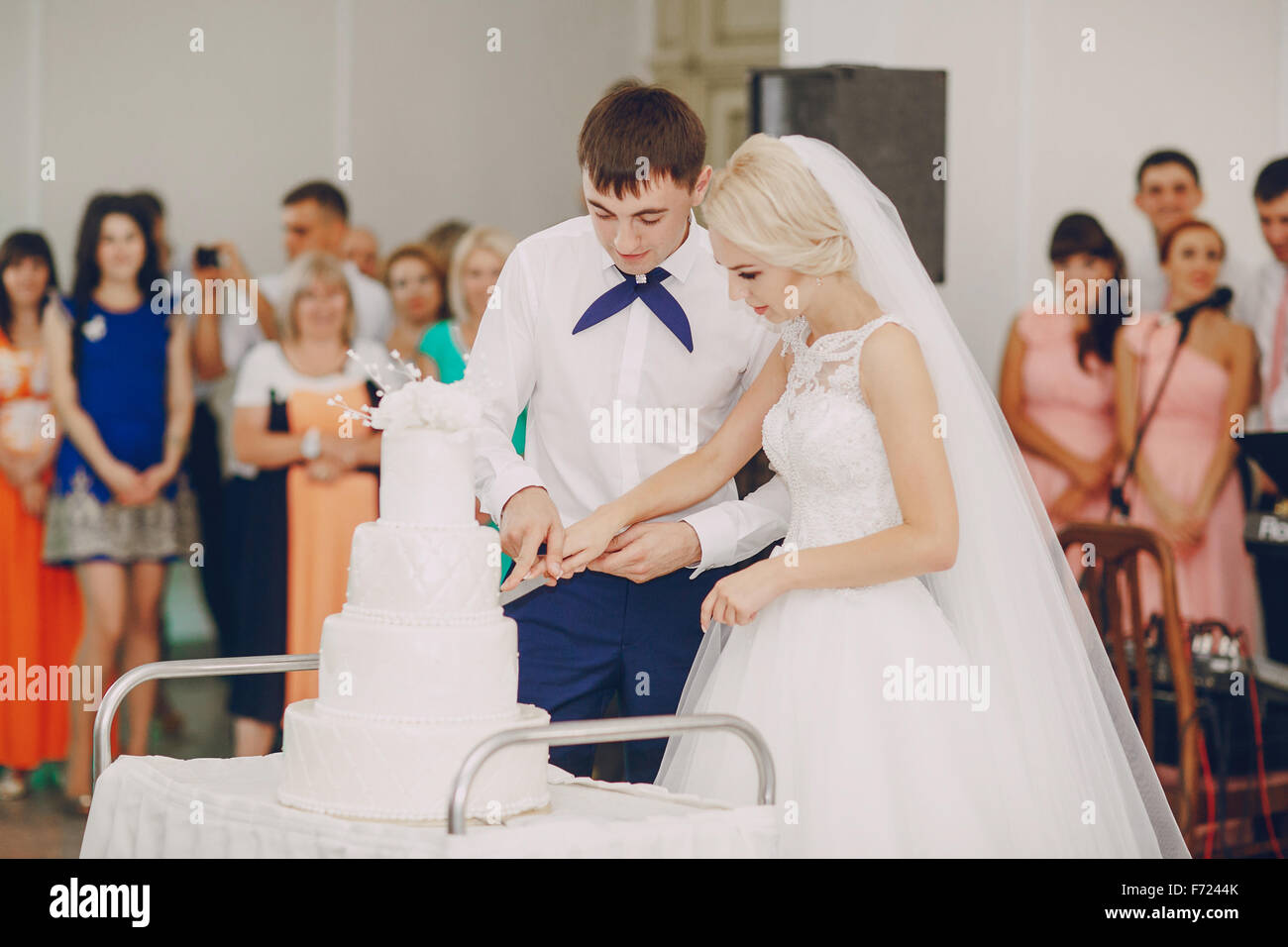 Young bride cutting wedding cake hi-res stock photography and images ...