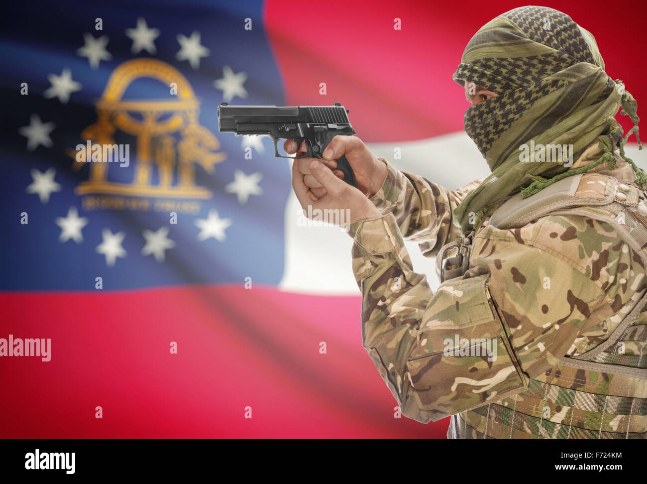 Male in muslim keffiyeh with gun in hand and flag on background series ...