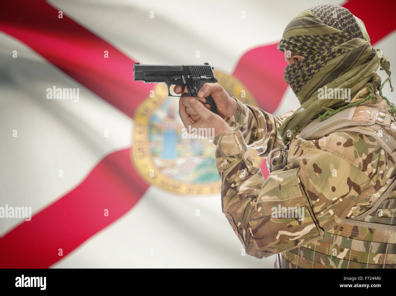 Male in muslim keffiyeh with gun in hand and flag on background series ...