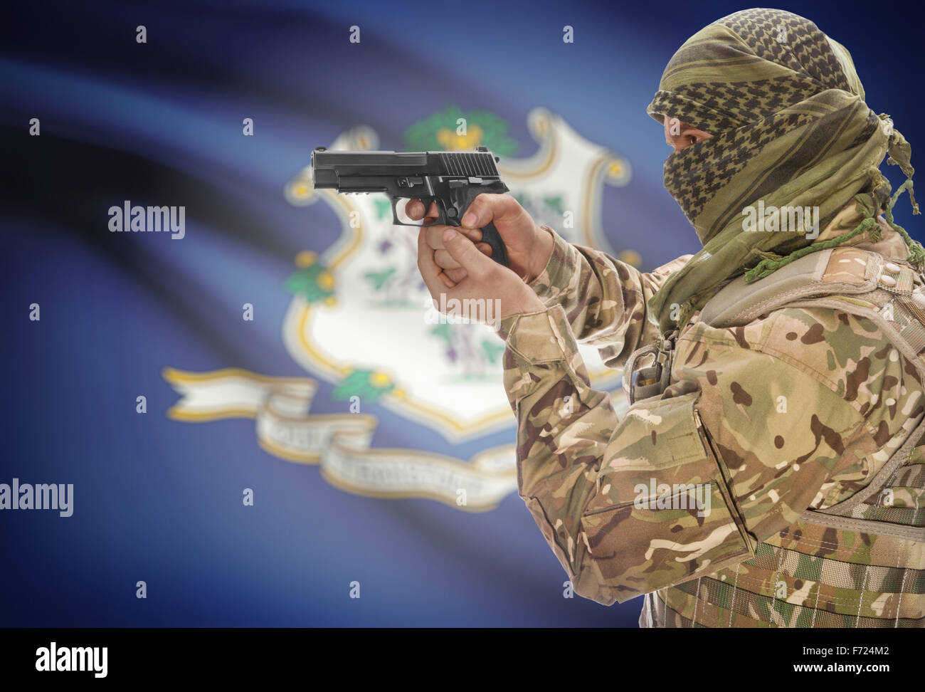 Male in muslim keffiyeh with gun in hand and flag on background series ...