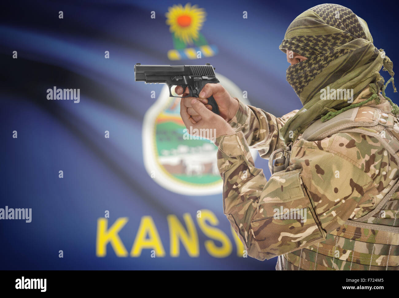 Male in muslim keffiyeh with gun in hand and flag on background series ...